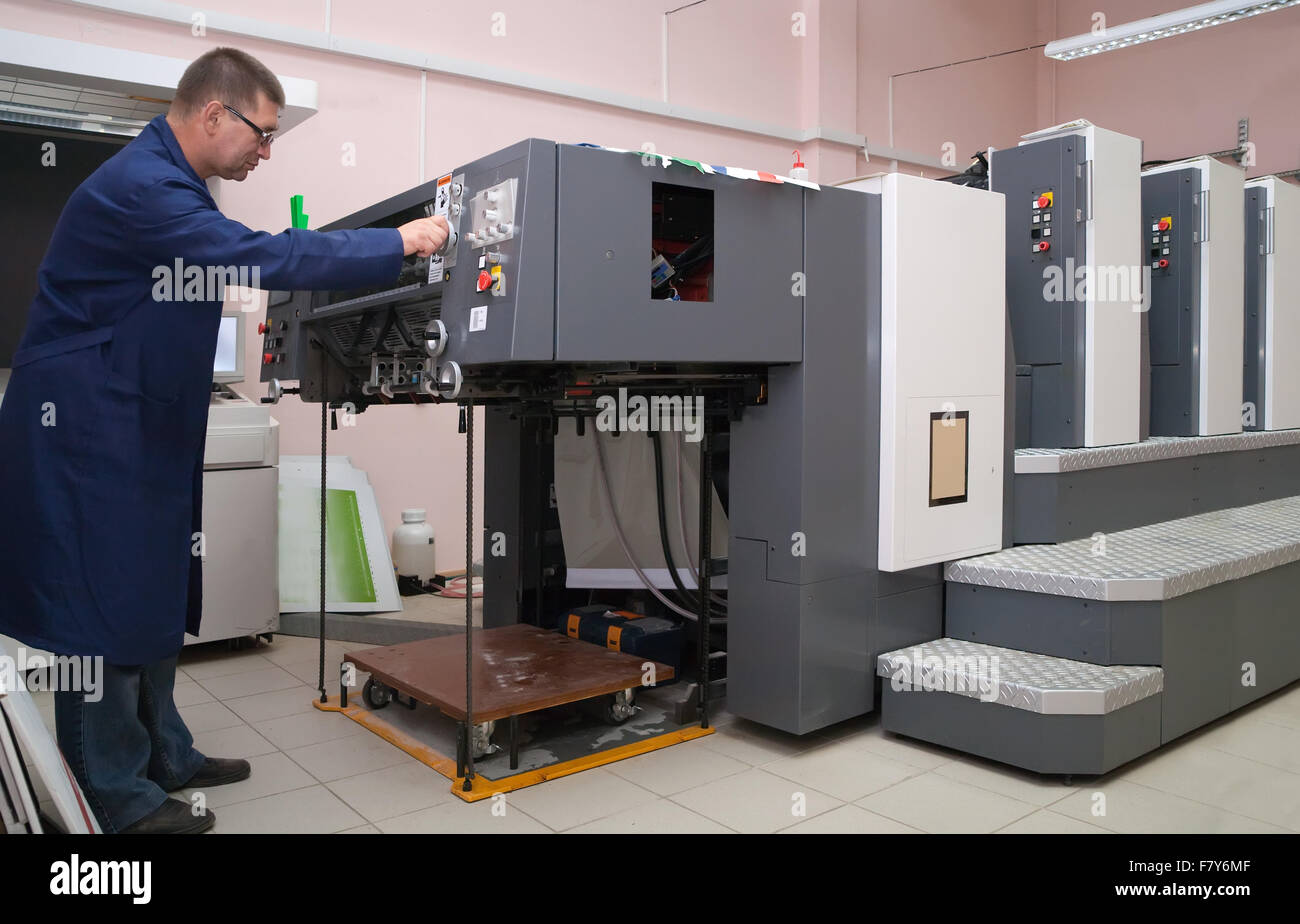 Printer working at his modern offset machine Stock Photo - Alamy