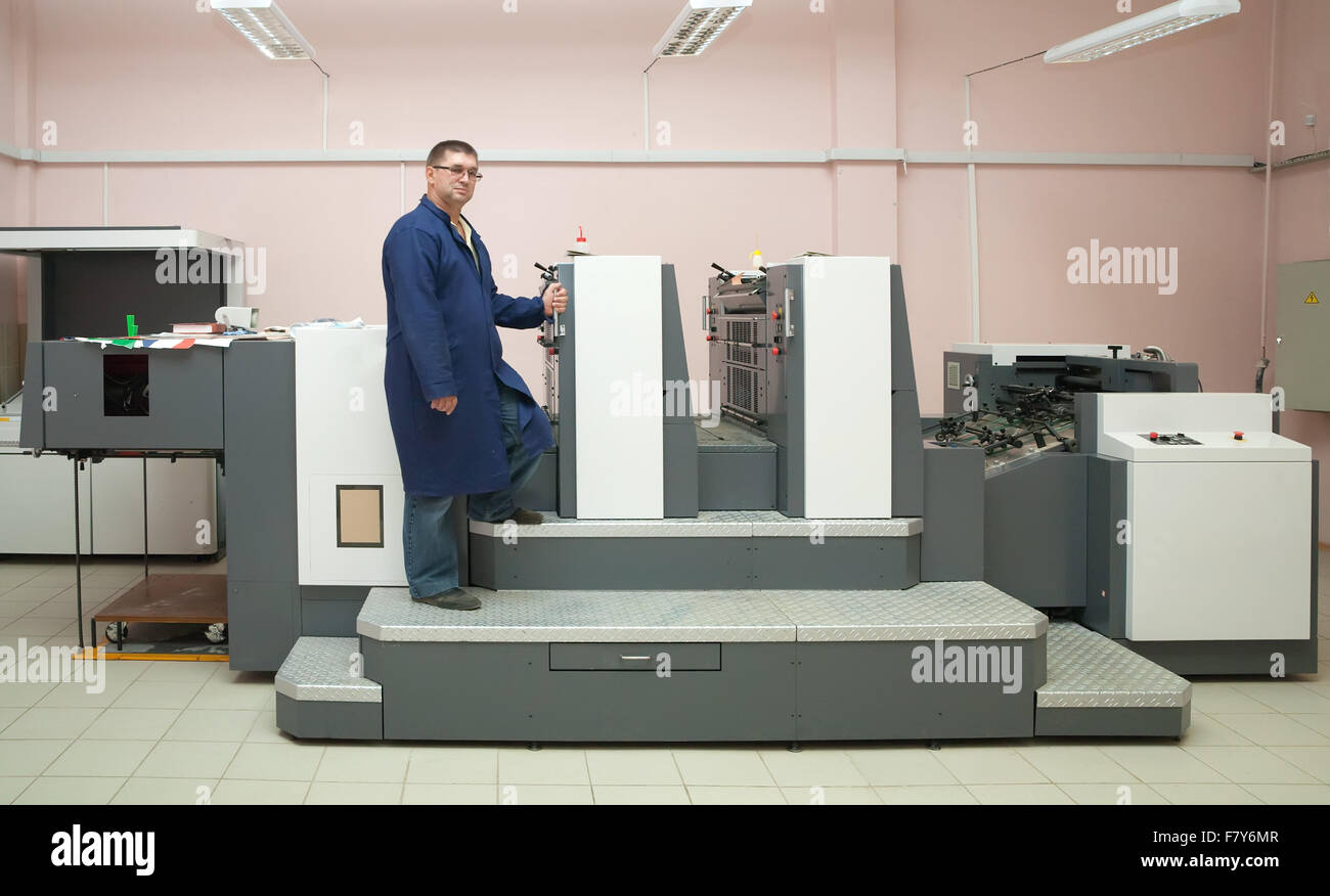 Printer working at his modern offset machine Stock Photo - Alamy