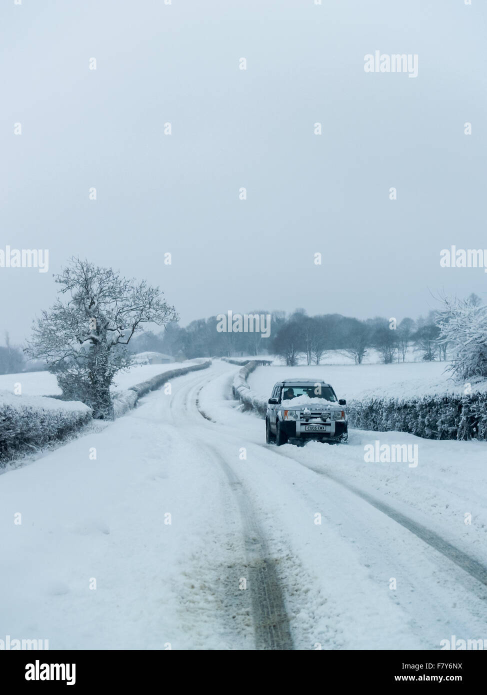 A 4x4 Land Rover vehicle drives through hazardous deep snow and ice on ...