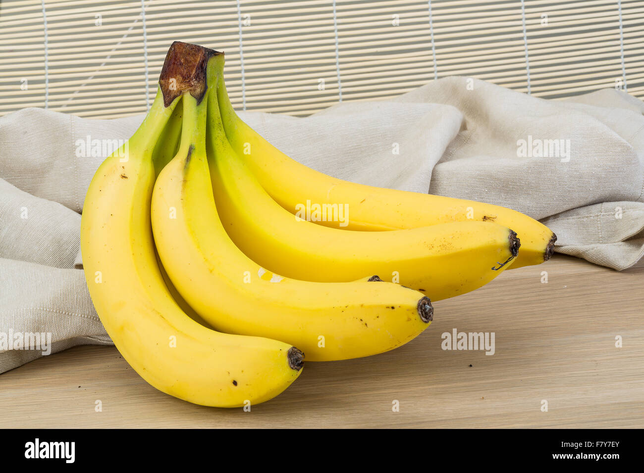 Ripe Banana branch on the wooden background Stock Photo - Alamy