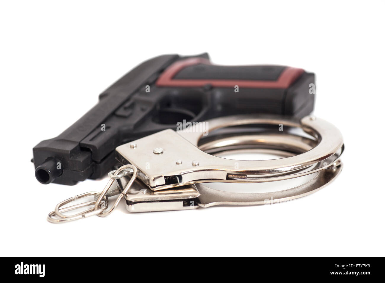 Gun and handcuffs isolated on white background Stock Photo - Alamy