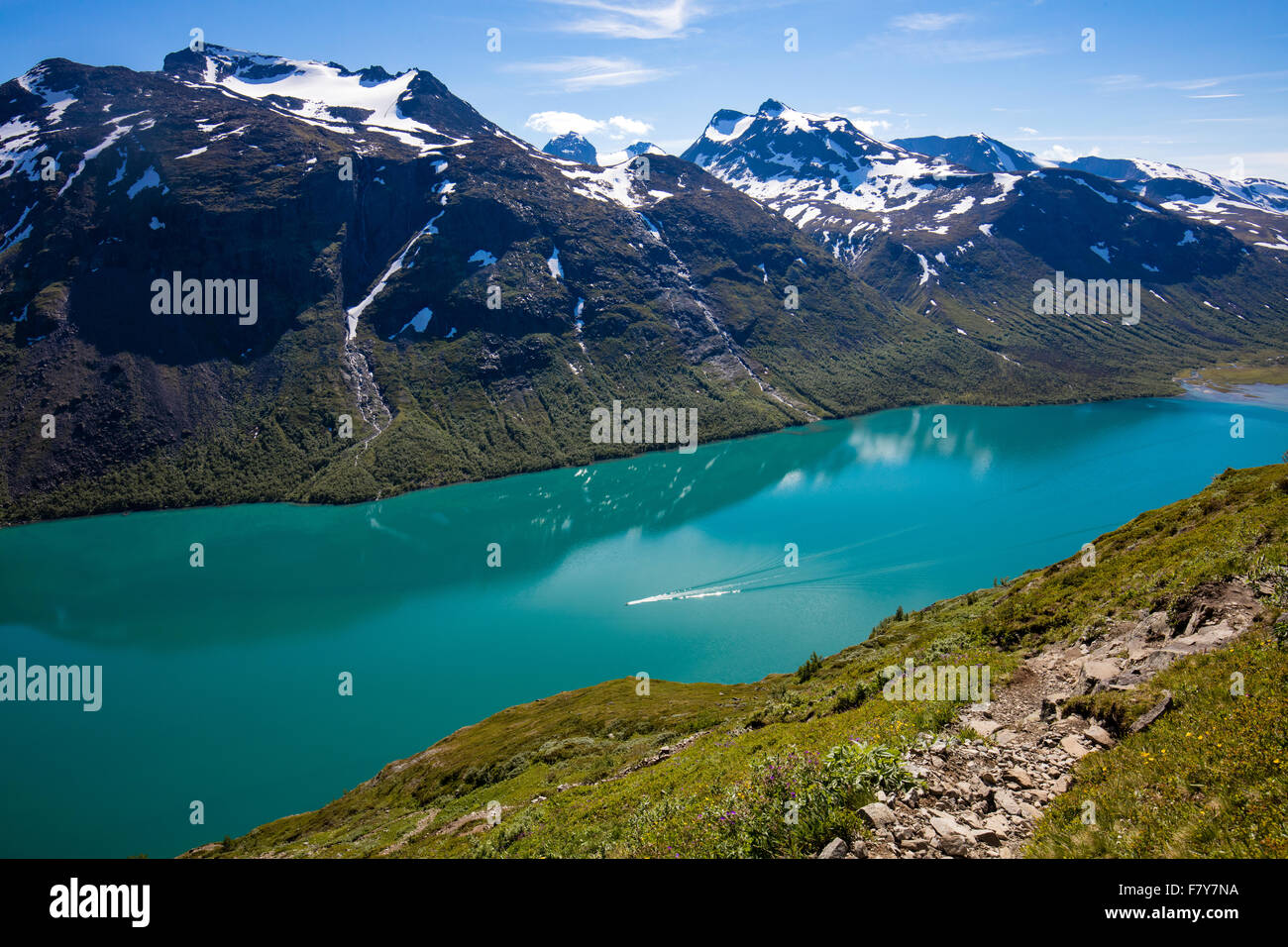 The turquoise mirror of Lake Gjende with ferry boat between Memurubu ...