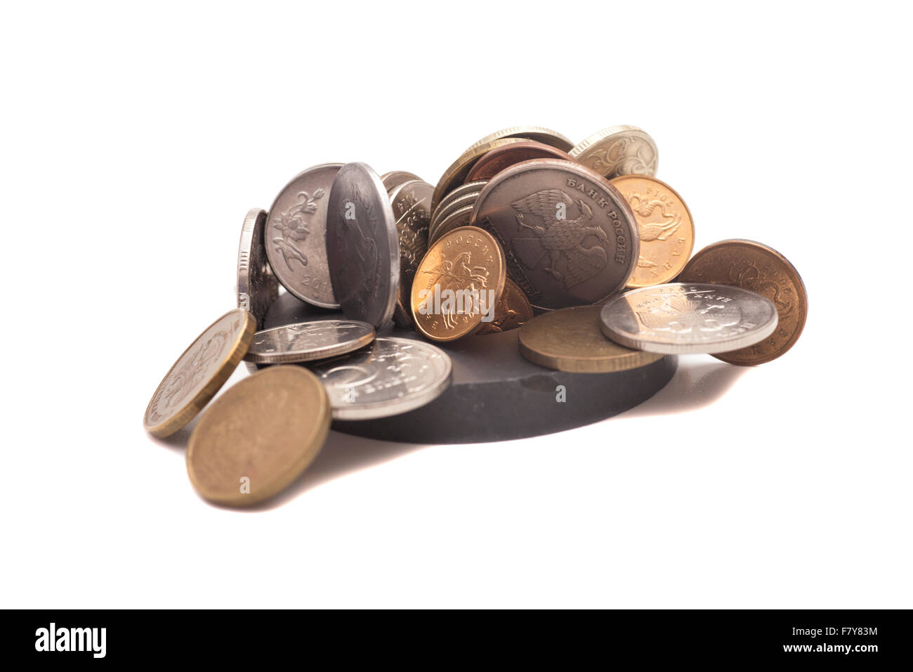 Coins attracted by magnet isolated on white background Stock Photo - Alamy