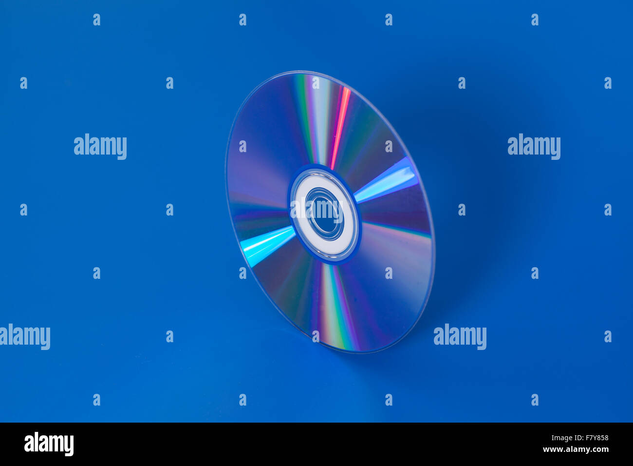 Compact disk on blue background Stock Photo - Alamy