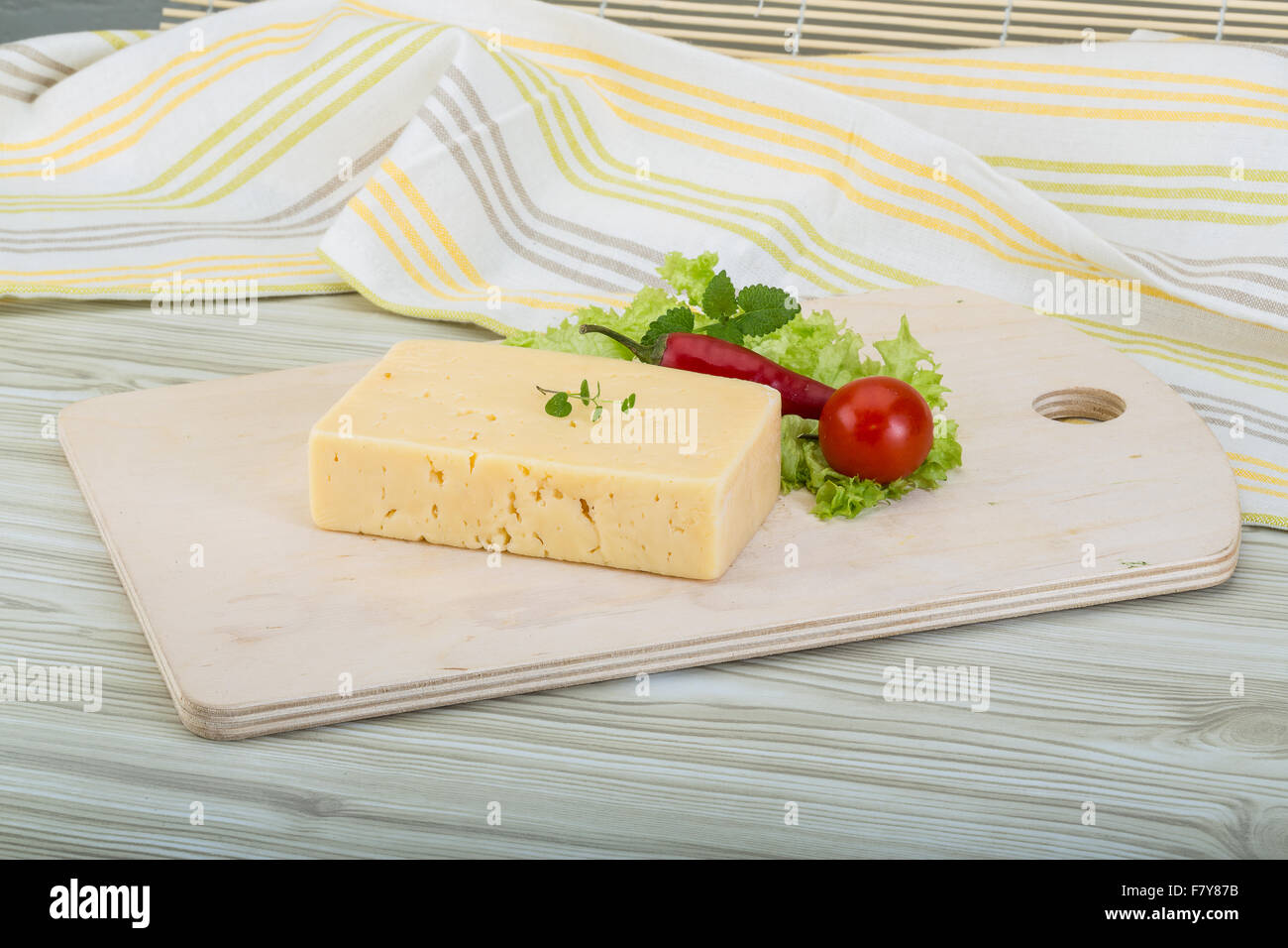 Block of Yellow cheese with herbs on wood Stock Photo - Alamy