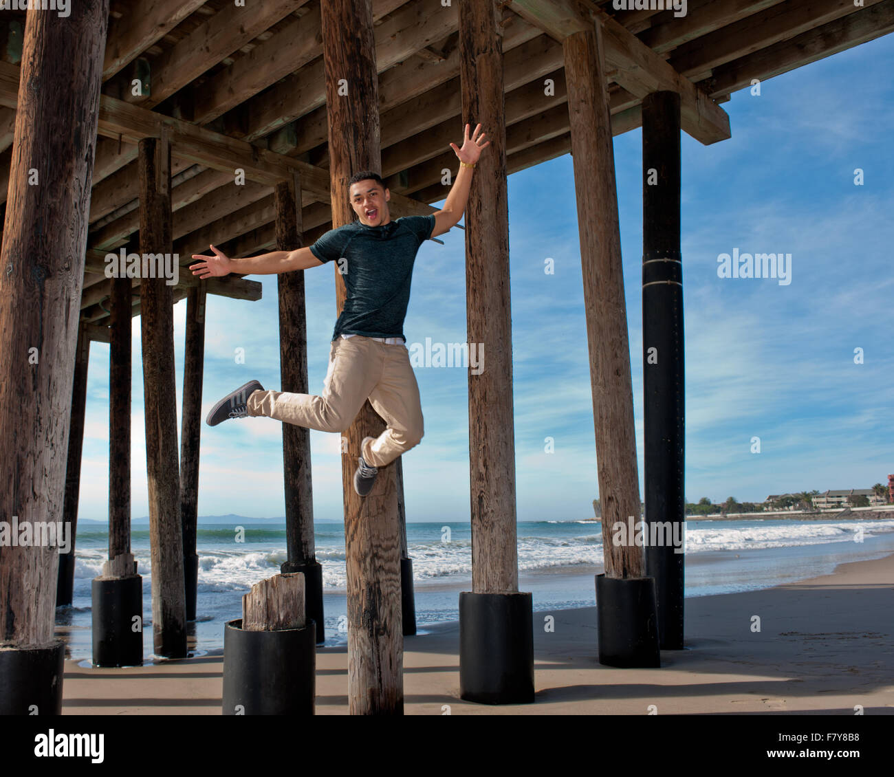 Handsome teenage man jumping high Stock Photo - Alamy