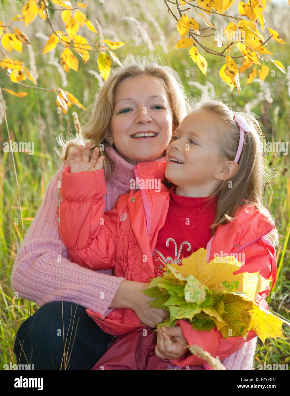 mother with daughter on meadow in fall Stock Photo - Alamy