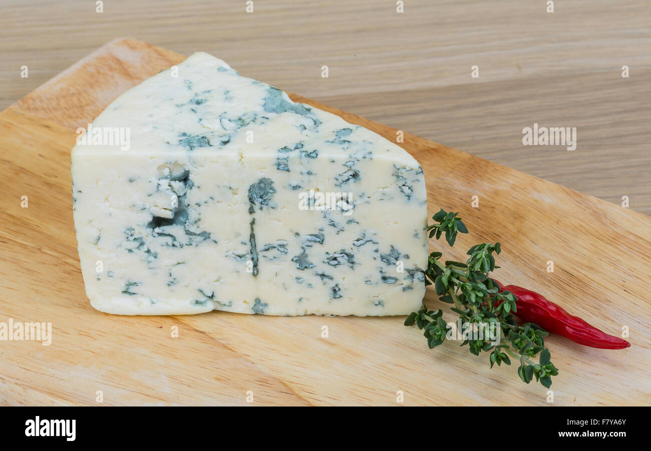 Blue cheese with mold on the wood background Stock Photo - Alamy