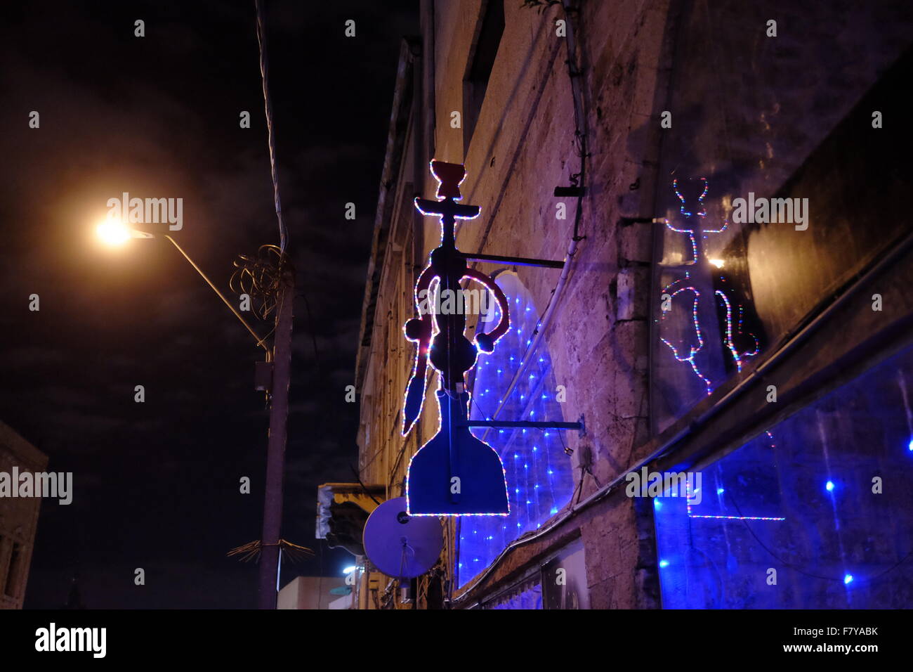 A lit on figure depicting a hookah pipe in old Jaffa Israel Stock Photo ...