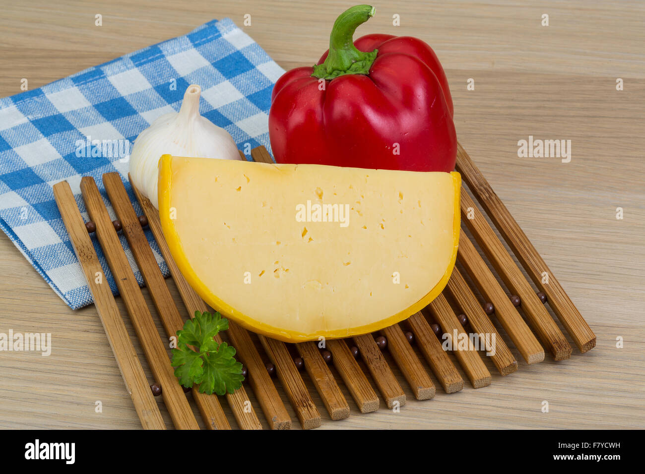 Yellow round cheese on the wood background Stock Photo - Alamy