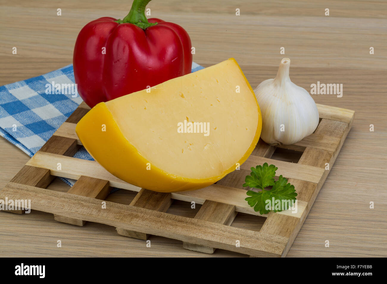 Yellow round cheese on the wood background Stock Photo - Alamy