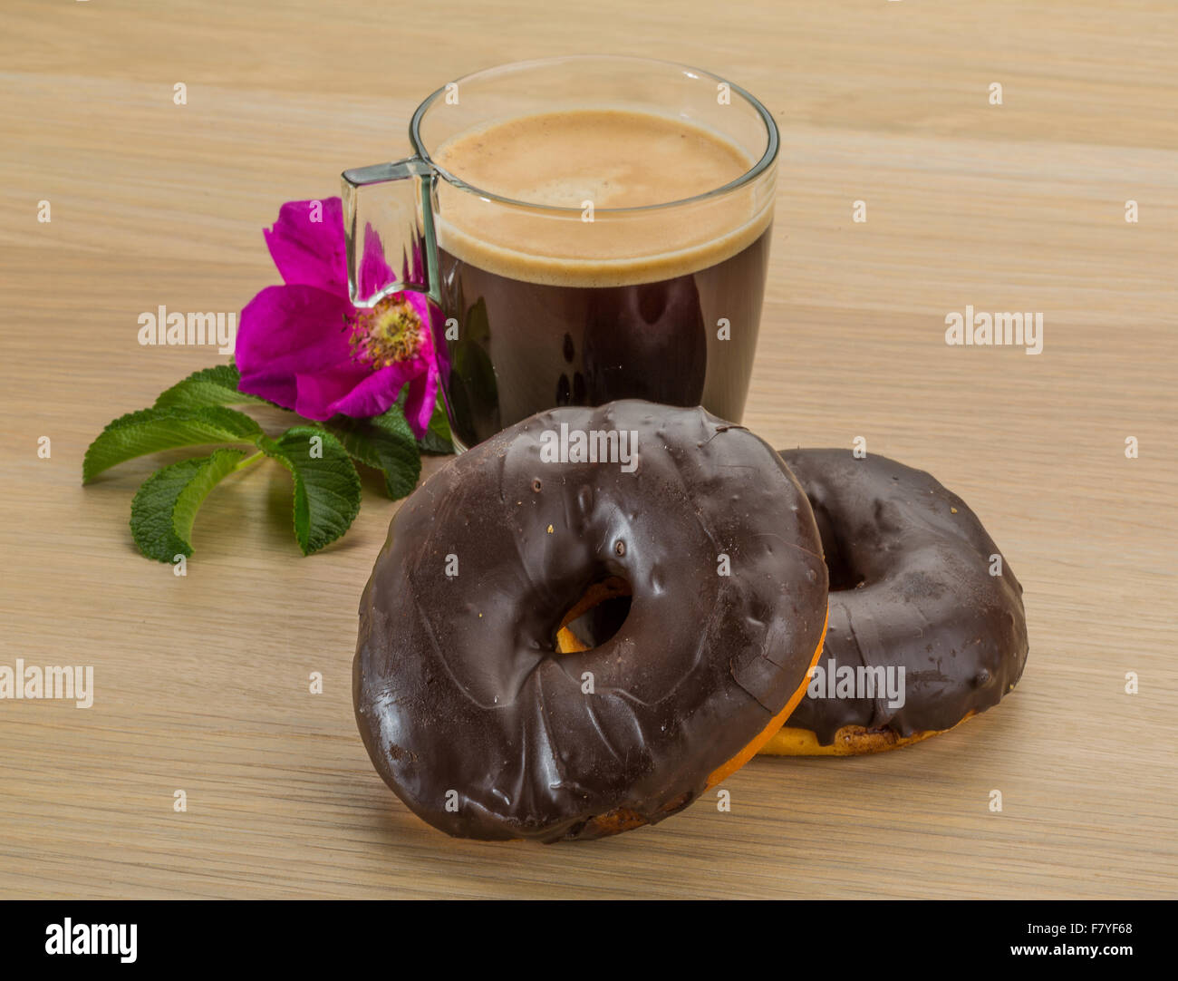 Chocolate donuts with coffee on the desk Stock Photo - Alamy