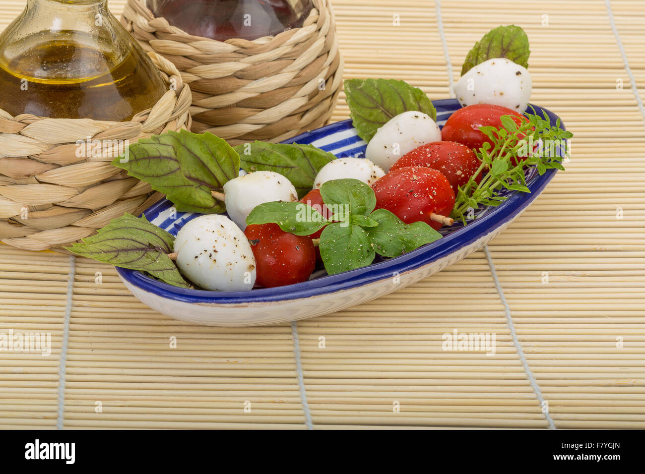Famous italian caprese salad with fresh basil leaves Stock Photo - Alamy