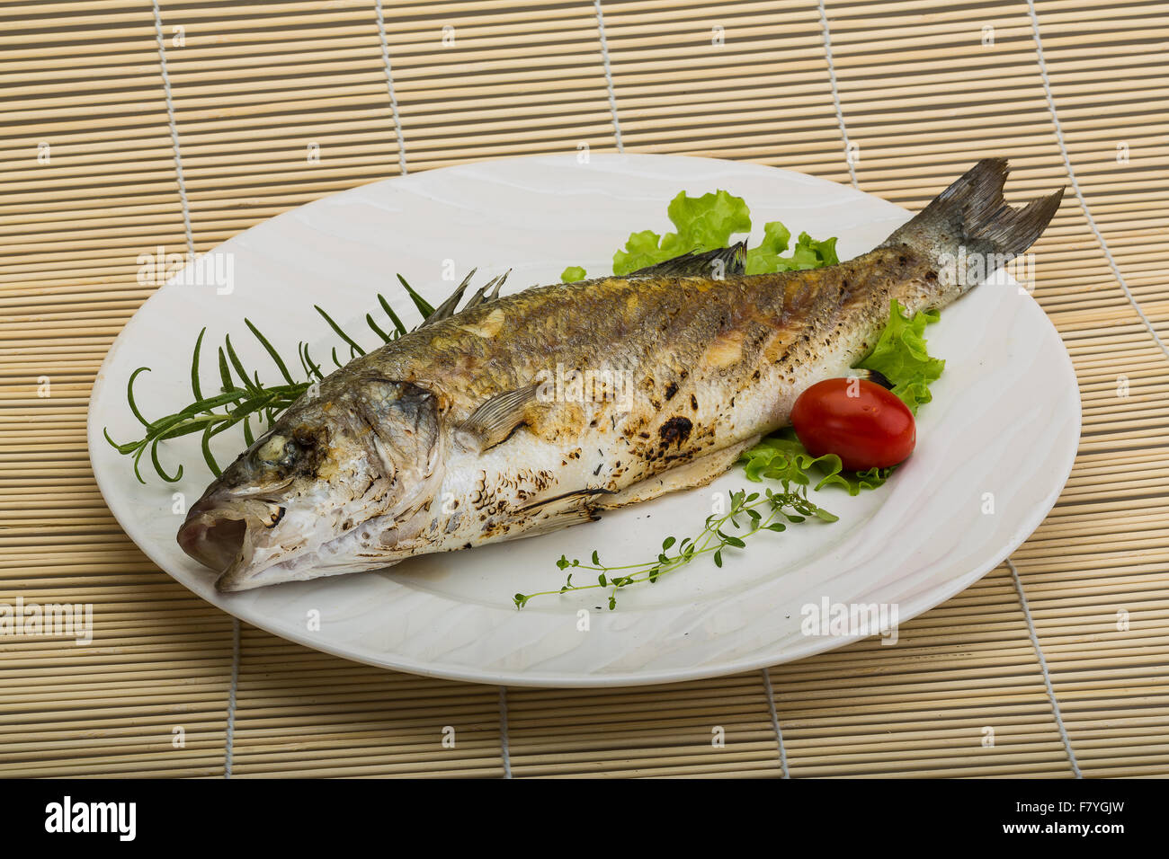 Grilled seabass fish - with rosemary and thyme Stock Photo - Alamy