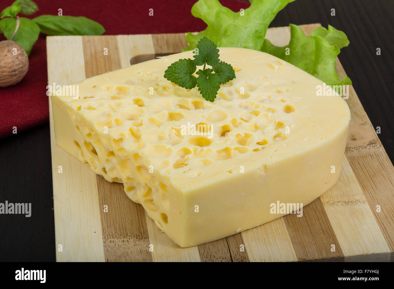 Yellow cheese - maasdam with salad leaves Stock Photo - Alamy