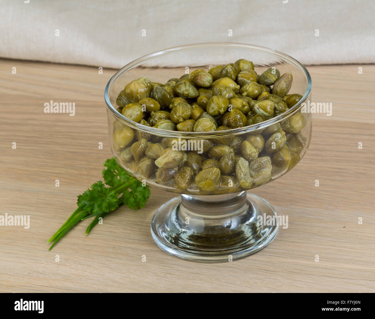 Capers in the bowl with green leaves Stock Photo - Alamy