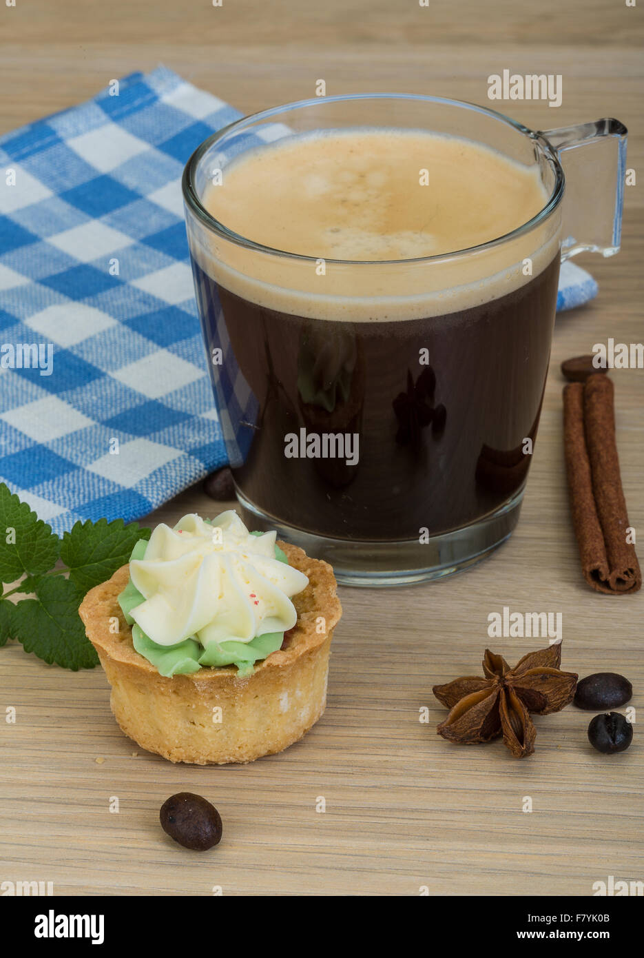 Coffee with sweet pastry and beans, cinnamon Stock Photo - Alamy
