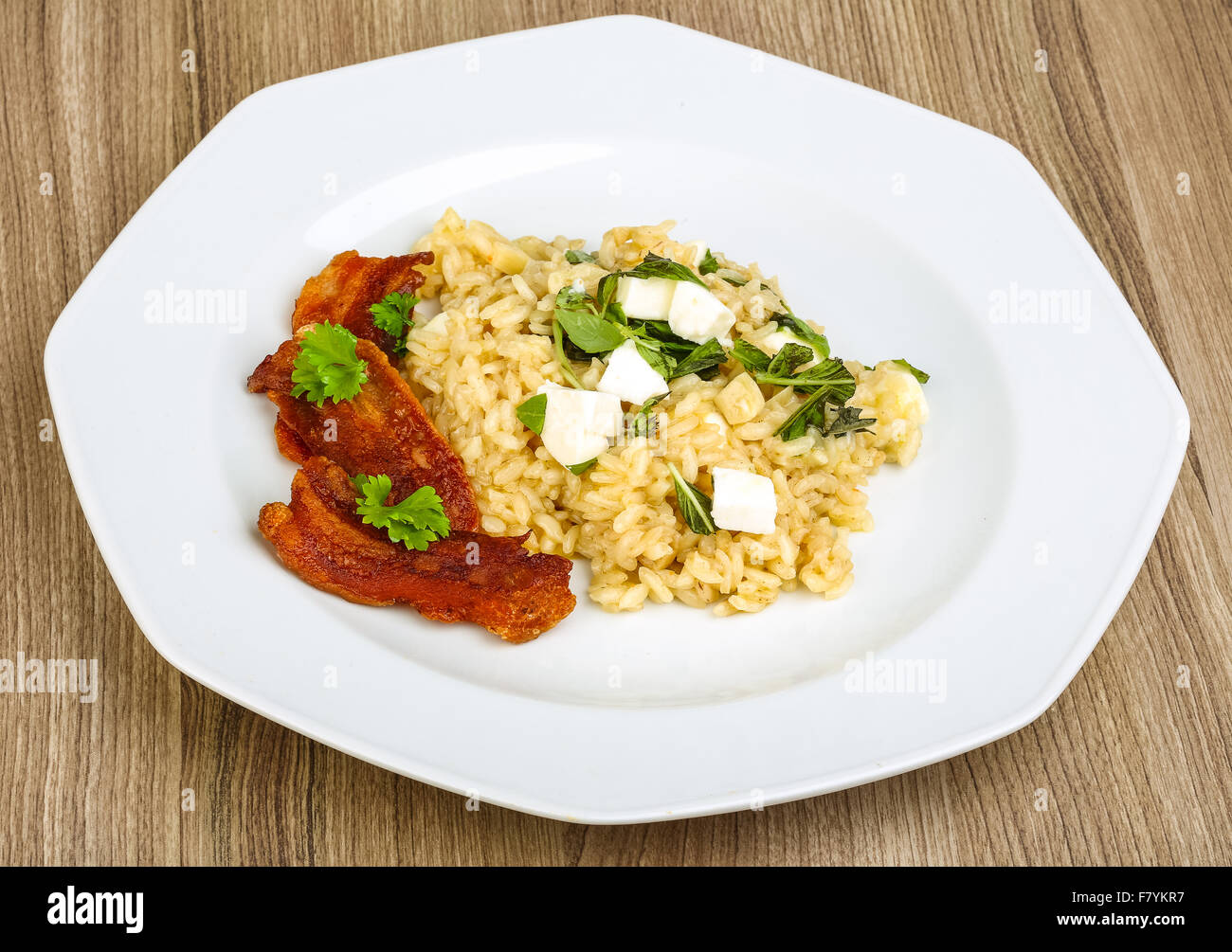 Risotto with mozzarella, basil leaves and bacon Stock Photo - Alamy
