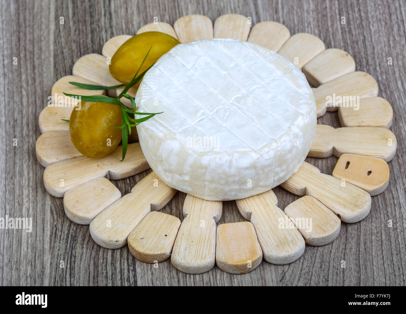 Round Brie cheese with yellow plums and estragon Stock Photo - Alamy