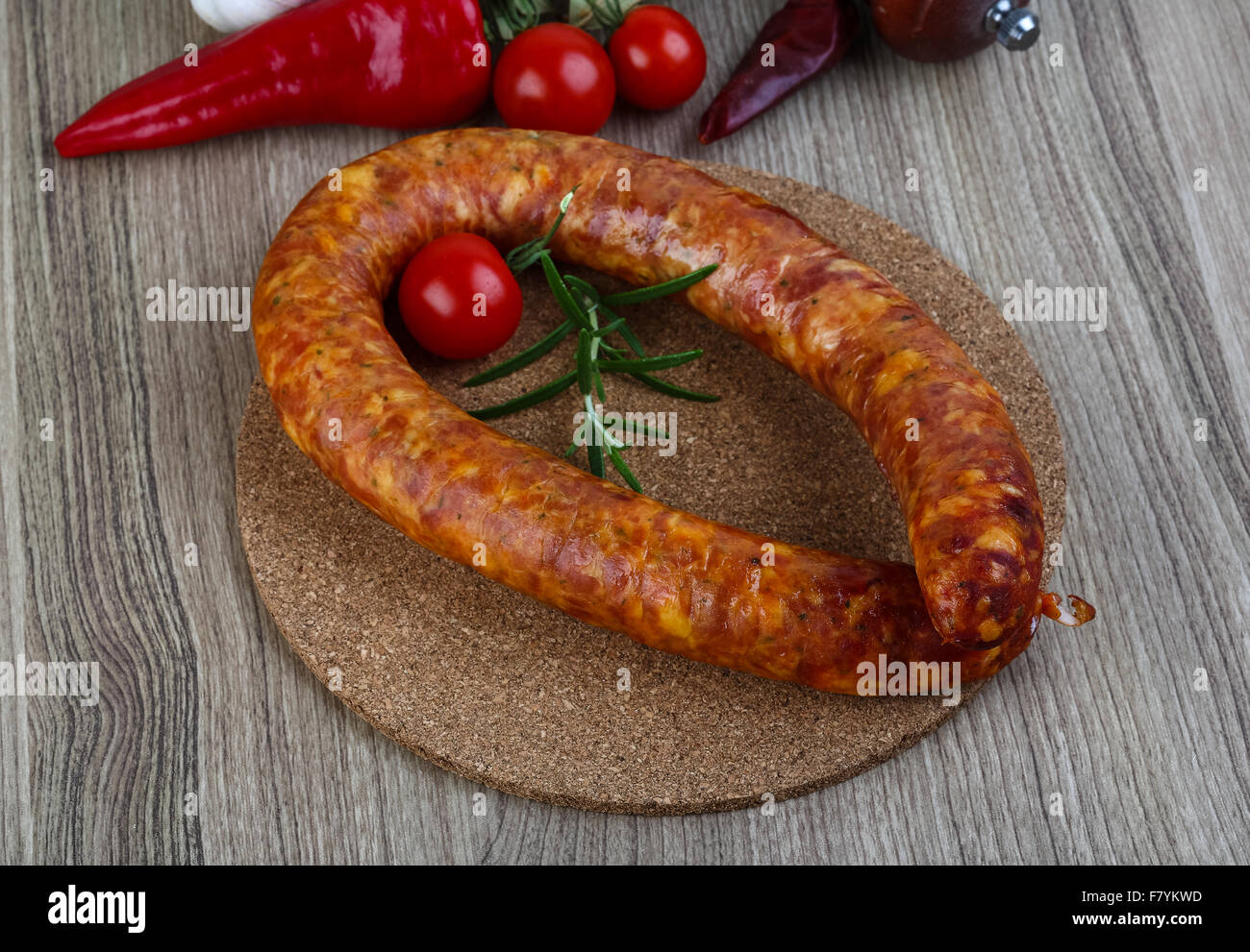 Sausage ring with rosemary and pepper on the wood background Stock ...