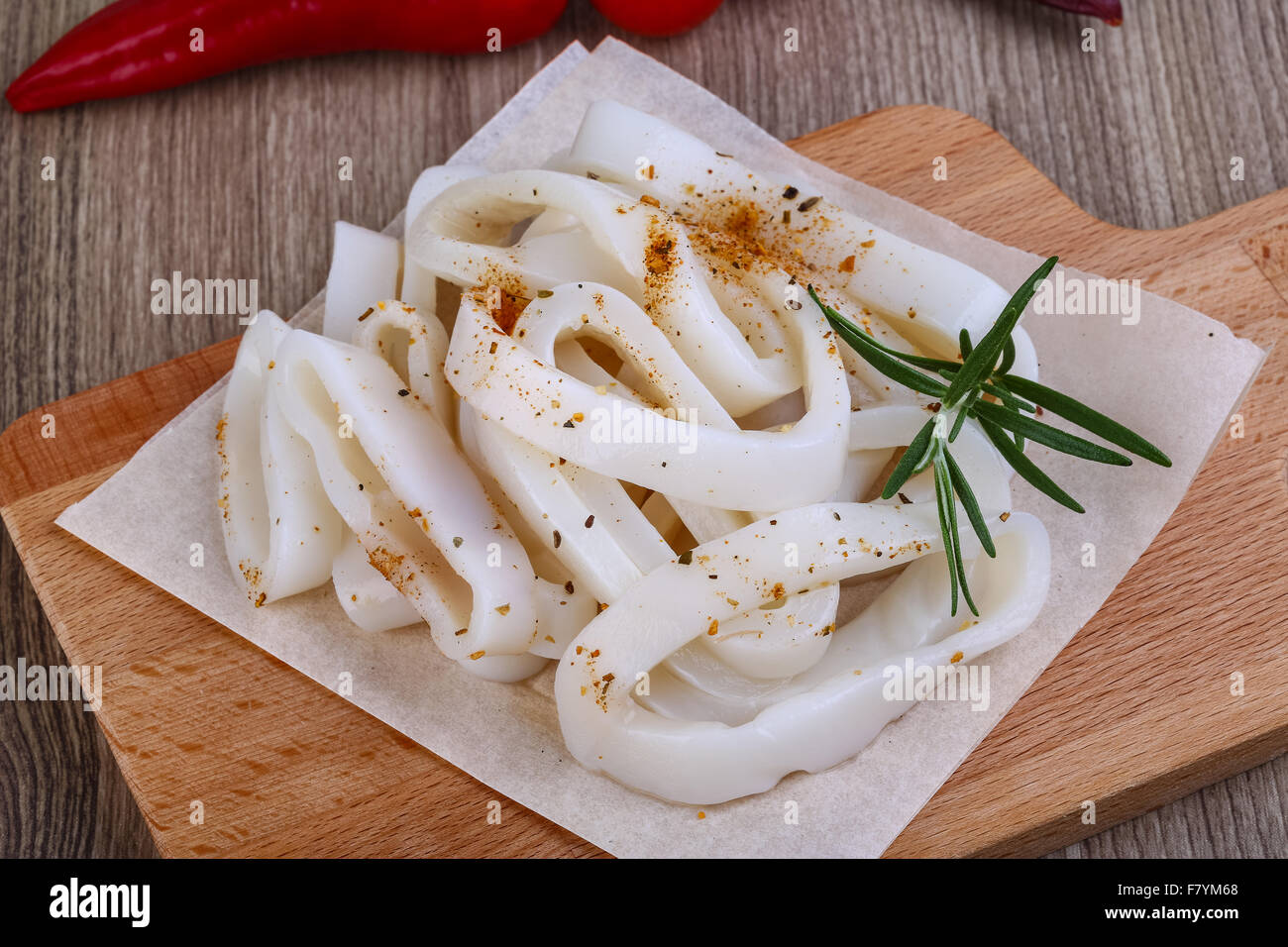 Raw squid rings with rosemary and spices - ready for cooking Stock ...