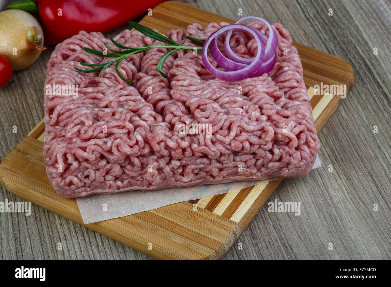 Raw minced pork meat with onion and rosemary ready for cooking Stock ...