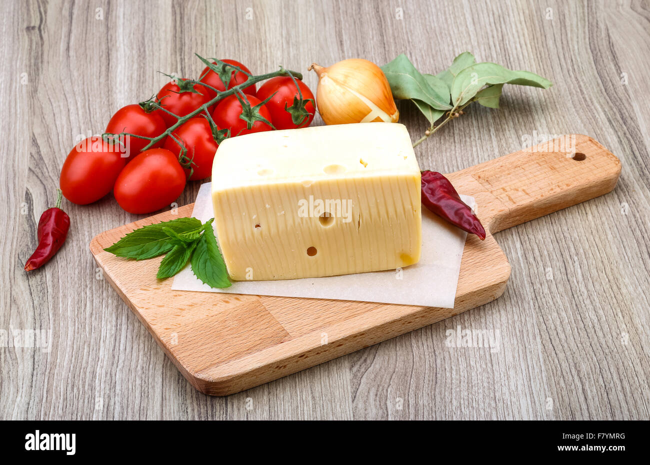Yellow cheese brick with mint leaves on the wood background Stock Photo ...