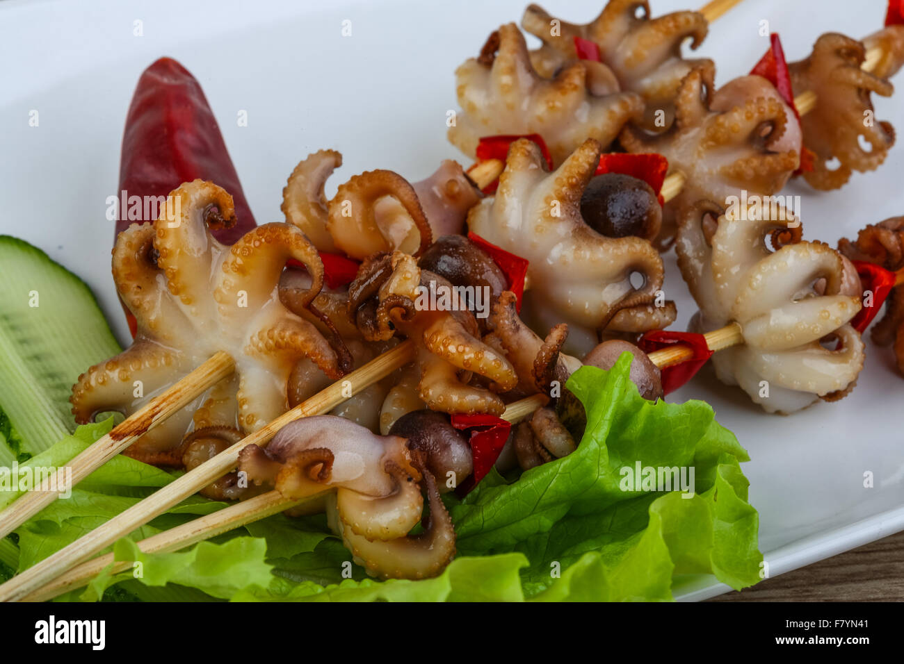 Grilled octopus skewers with red pepper and onion Stock Photo - Alamy