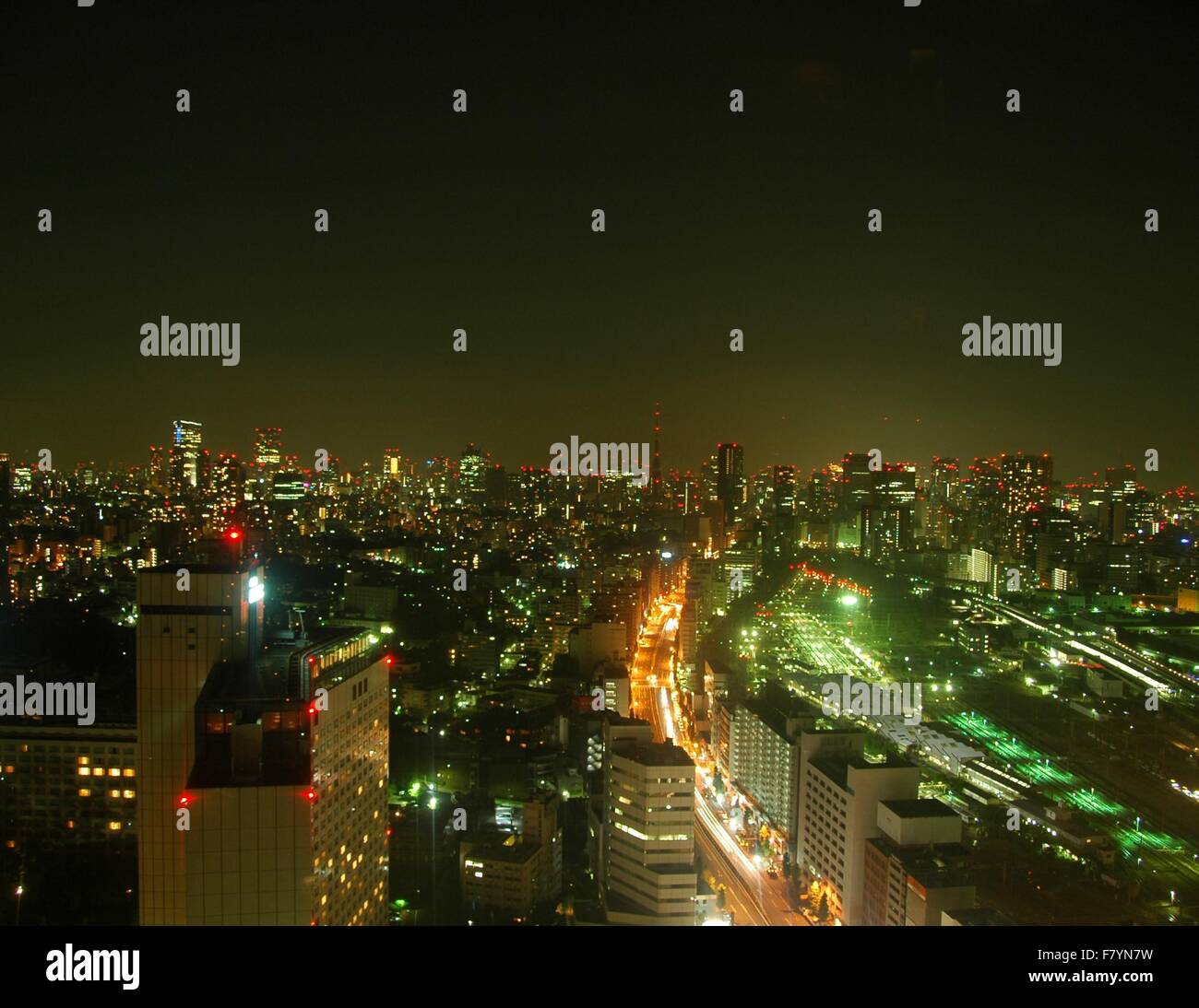 Tokyo lights at night, Tokyo, Japan. On the right are rail yards of the ...