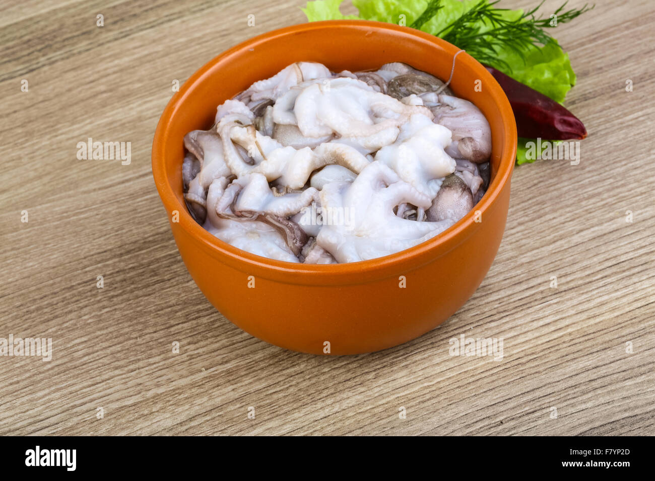 Raw baby octopus in the bowl ready for cooking Stock Photo - Alamy