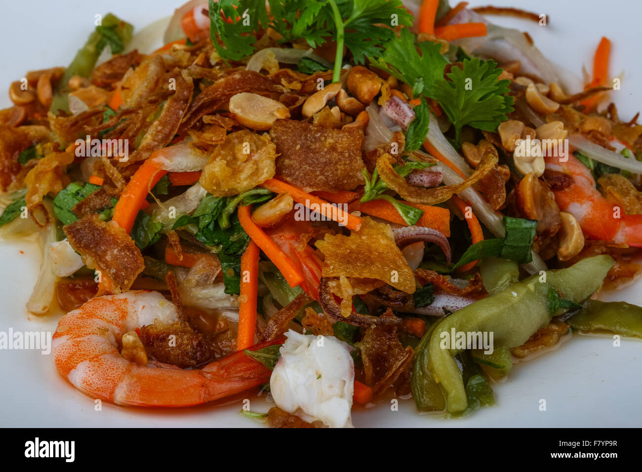 Traditional Asian seafood salad with nuts on wood background Stock ...