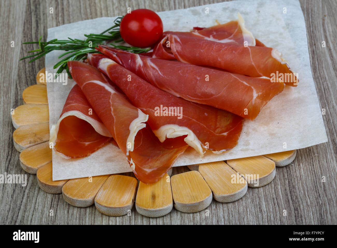 Spanish traditional snack - Jamon with tomato and rosemary Stock Photo ...