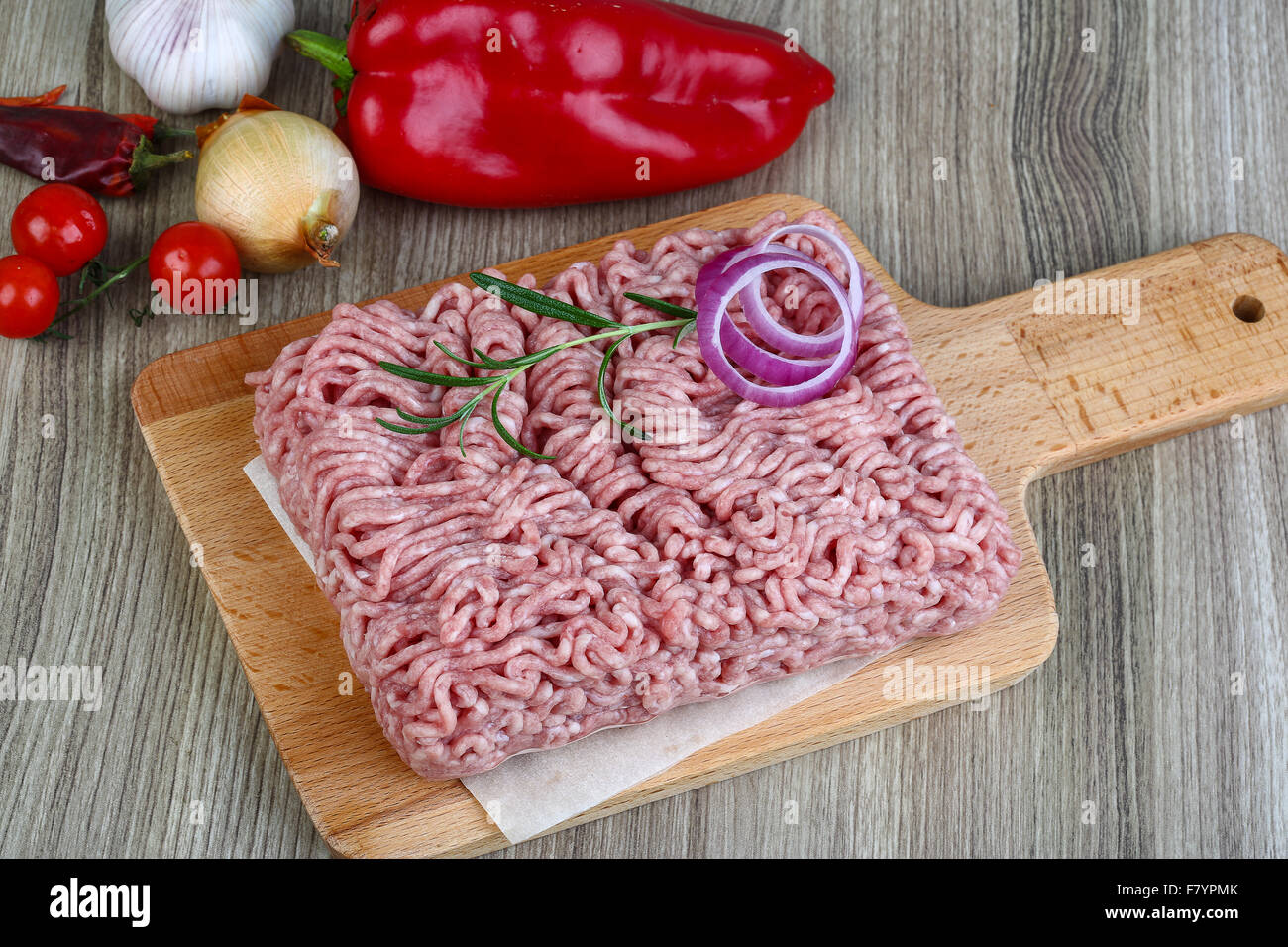 Raw minced pork meat with onion and rosemary ready for cooking Stock ...