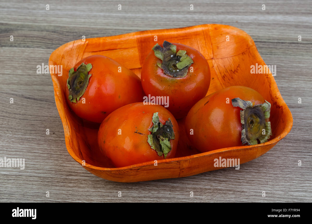 Fresh ripe juicy Persimmon fruit on the wood background Stock Photo - Alamy