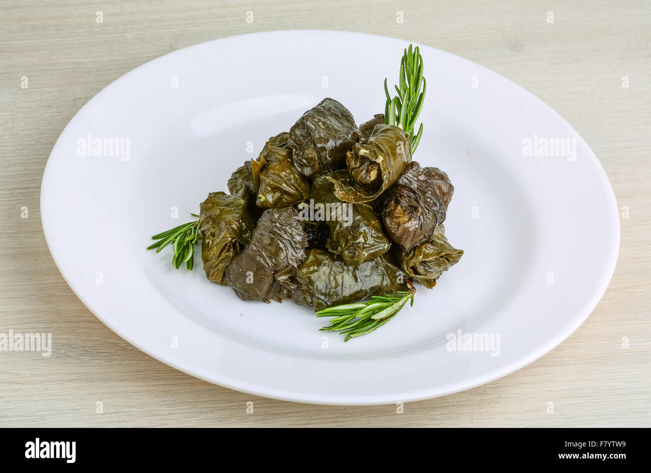 Greek dolma in grape leaves with meat served rosemary Stock Photo - Alamy