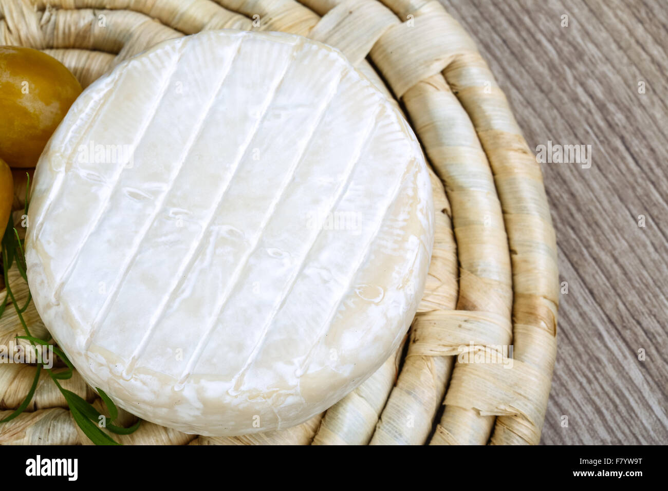 Round Brie cheese with yellow plums and estragon Stock Photo - Alamy