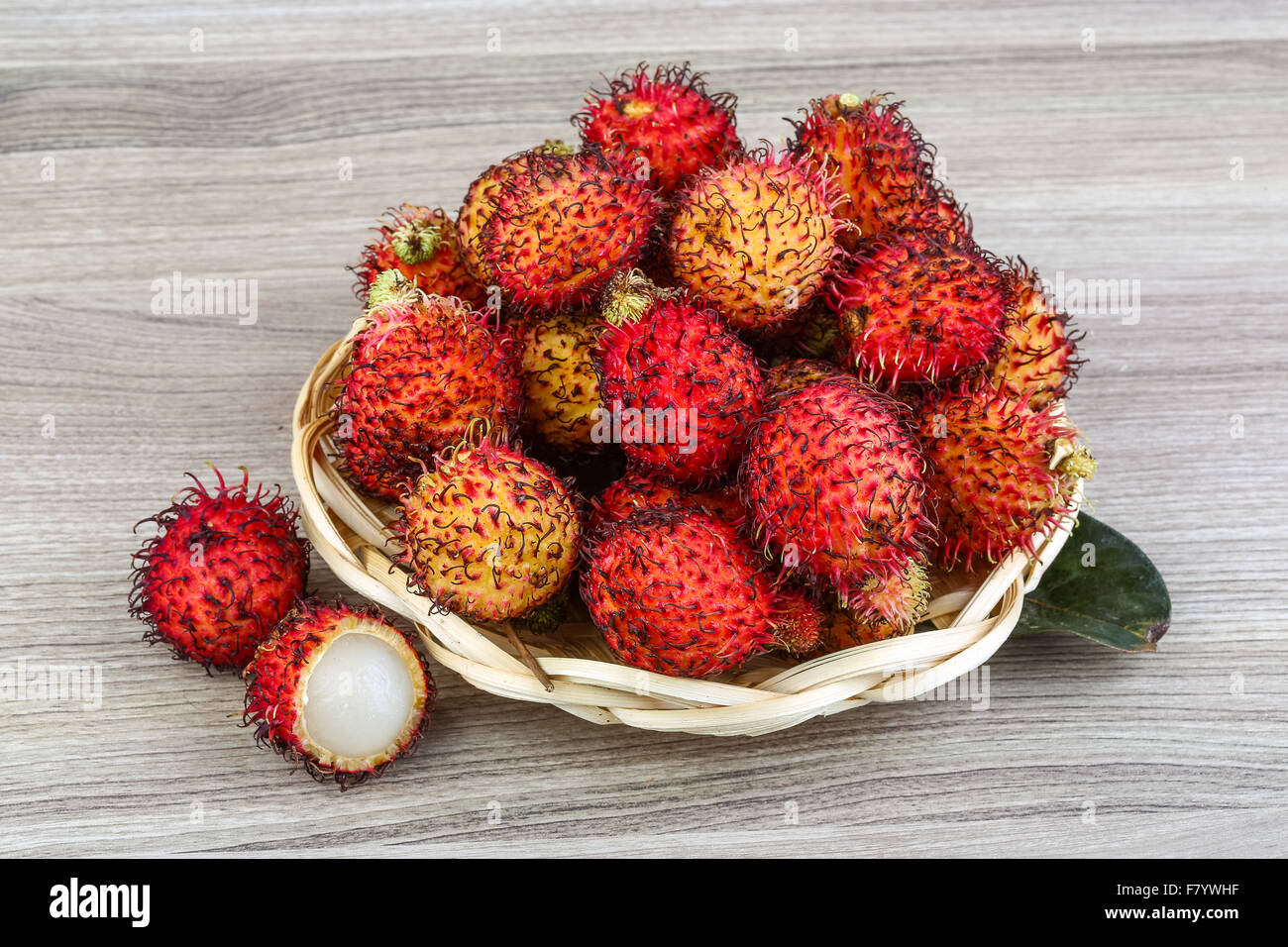 Asian fruit - rambutan - on the wood background Stock Photo - Alamy