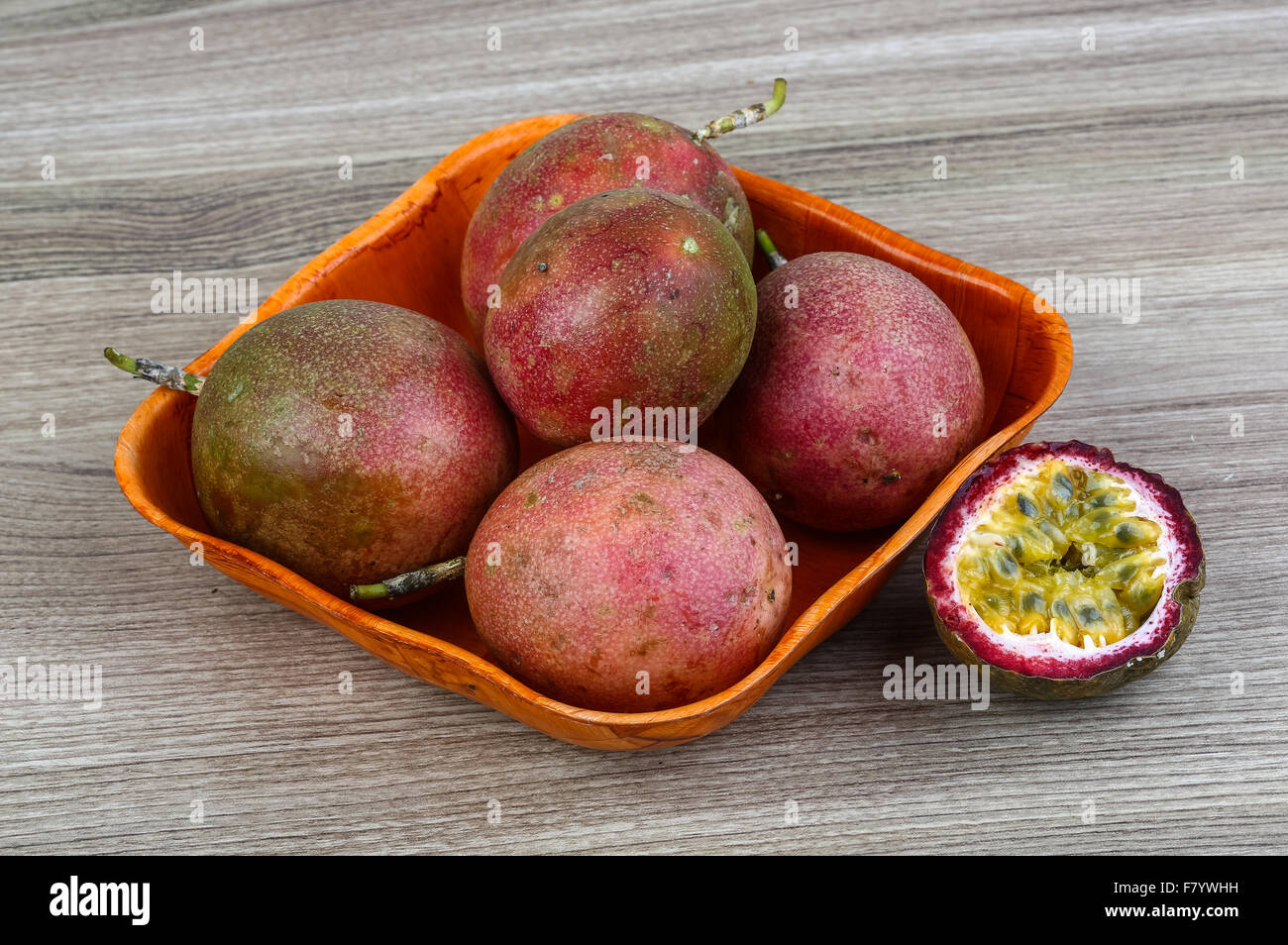 Fresh tropical fruit - Passionfruit - in the basket o wood background ...