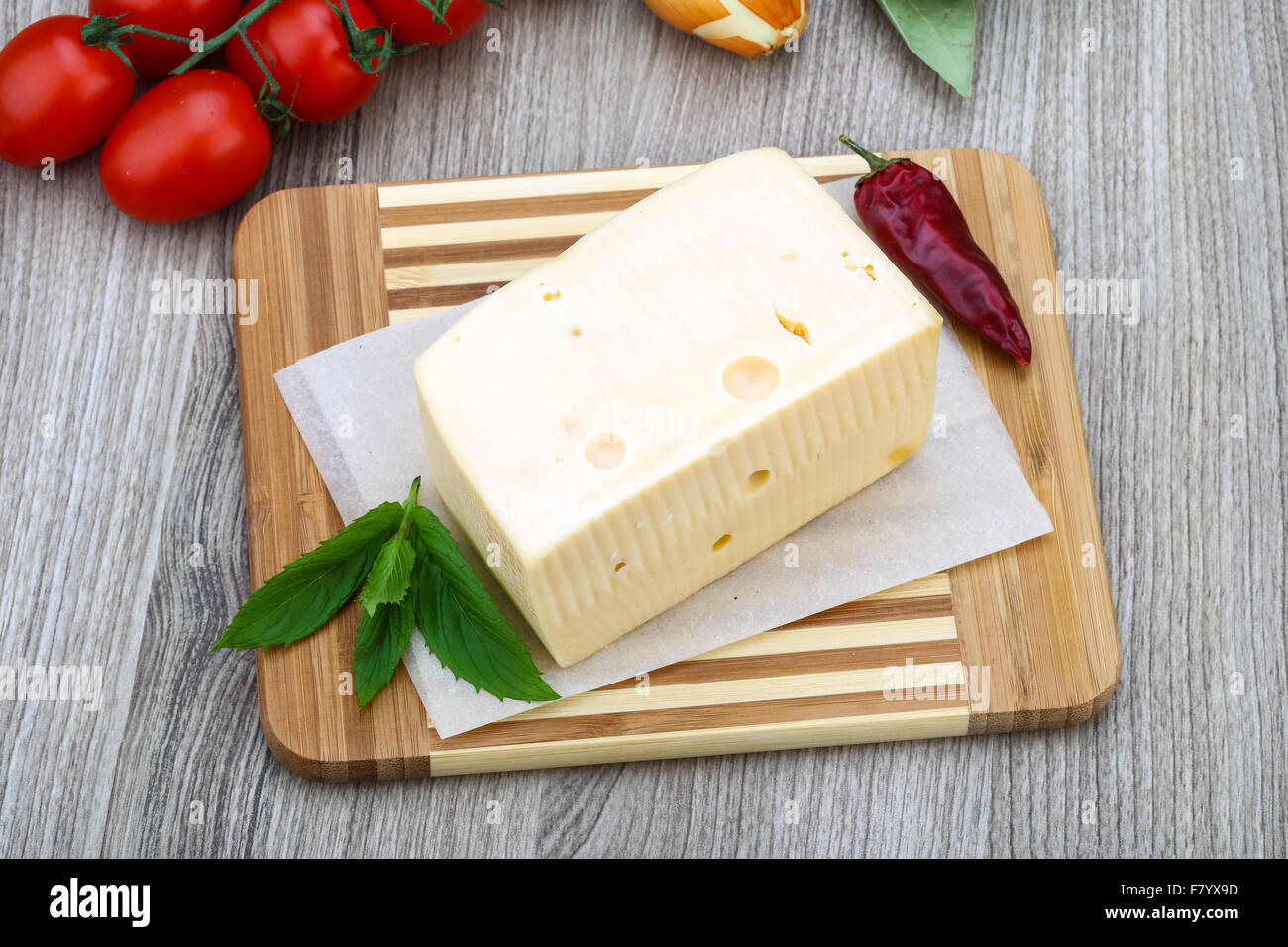 Cheese brick with mint leaves on the wood background Stock Photo - Alamy