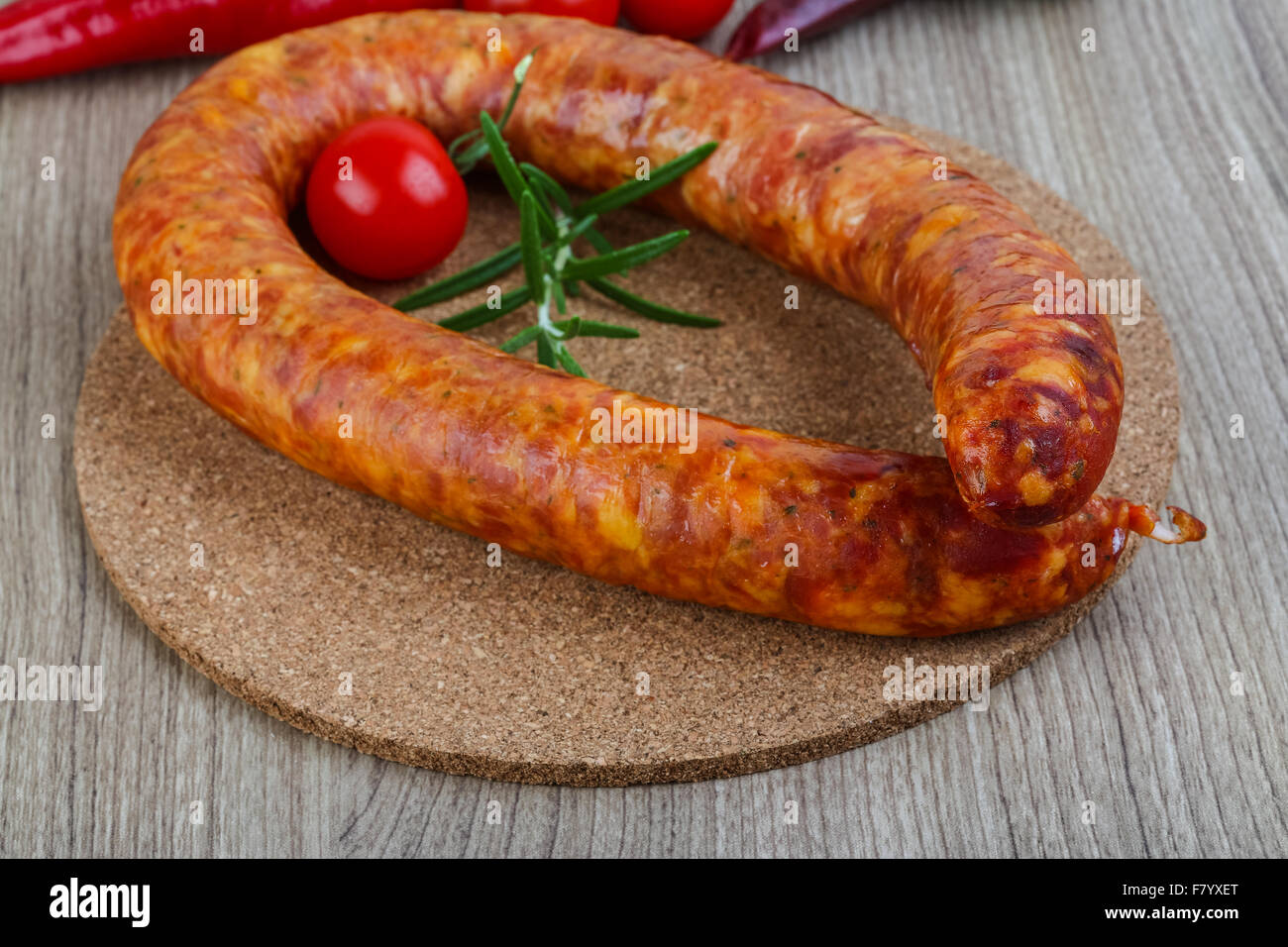 Sausage ring with rosemary and pepper on the wood background Stock ...