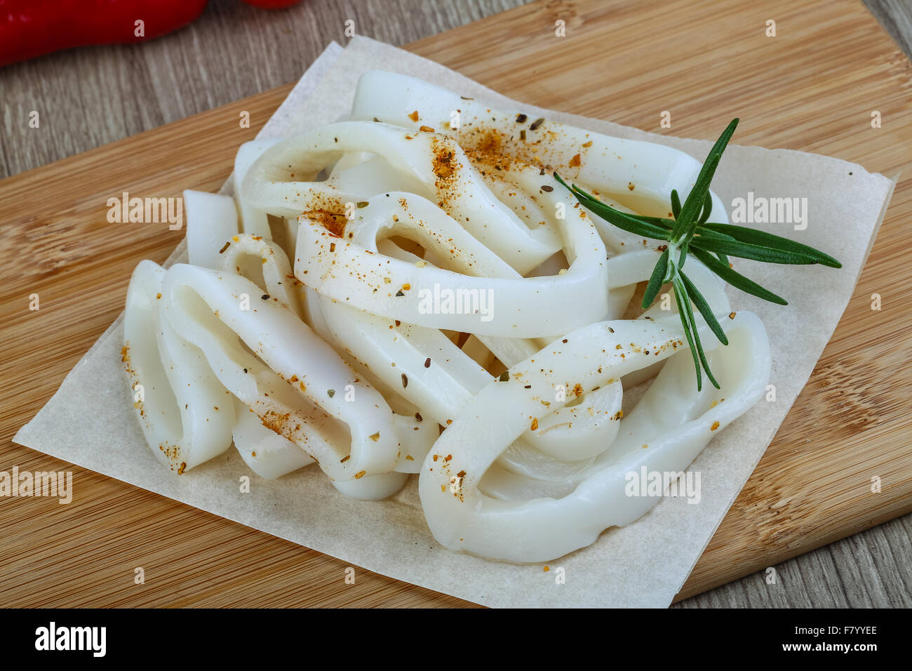 Raw squid rings with herbs - ready for cooking Stock Photo - Alamy