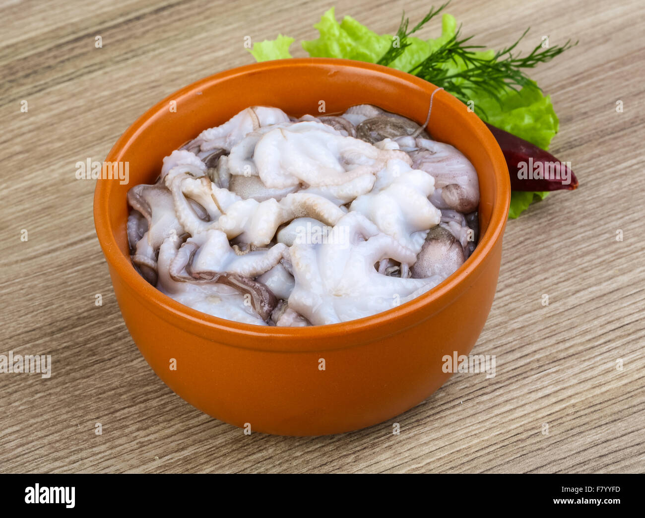 Raw baby octopus in the bowl ready for cooking Stock Photo - Alamy