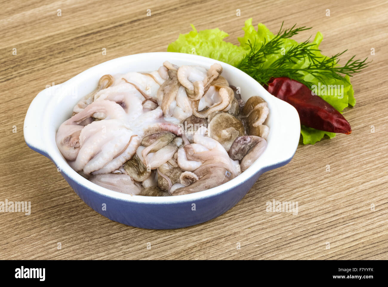 Raw baby octopus in the bowl ready for cooking Stock Photo - Alamy