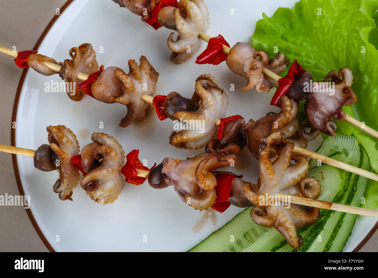 Grilled octopus skewers with red pepper and onion Stock Photo - Alamy