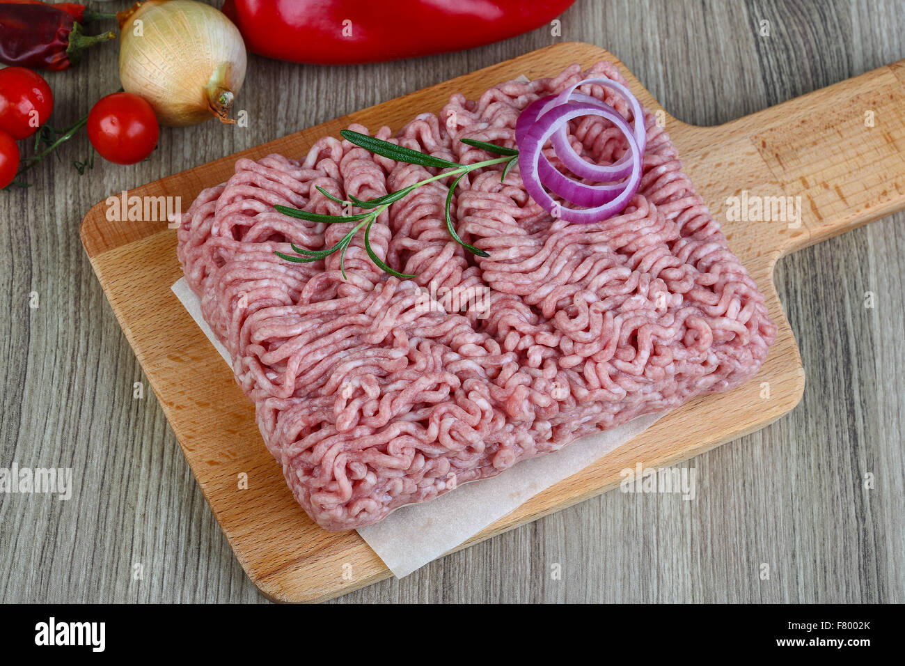 Raw minced pork meat with onion and rosemary ready for cooking Stock ...