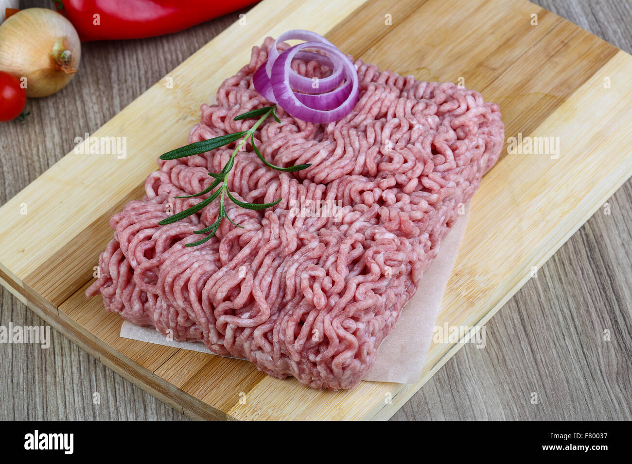 Raw minced pork meat with onion and rosemary ready for cooking Stock ...