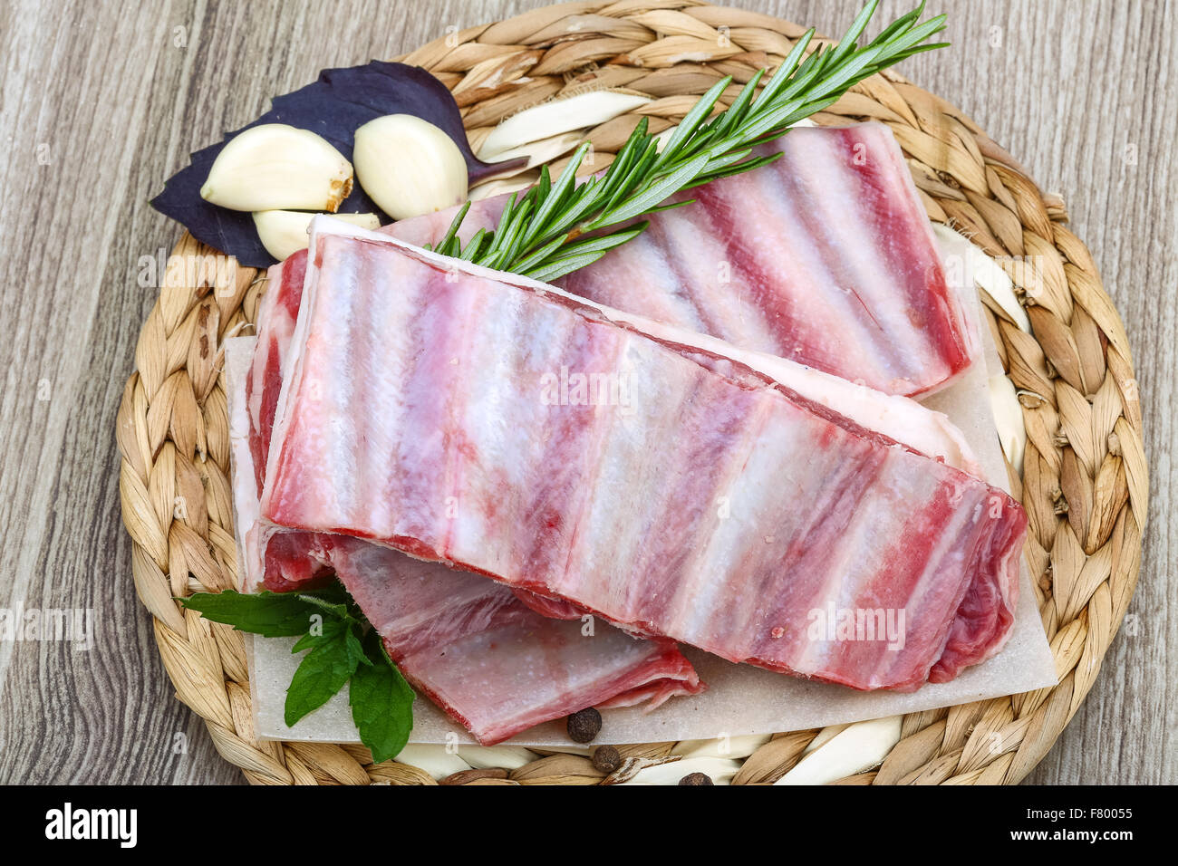 Fresh cold Raw lamb ribs with garlik and pepper - ready for cooking ...