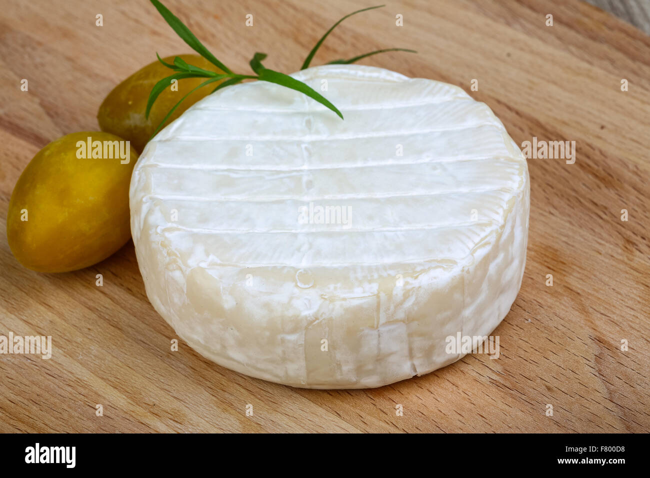 Round Brie cheese with yellow plums and estragon Stock Photo - Alamy