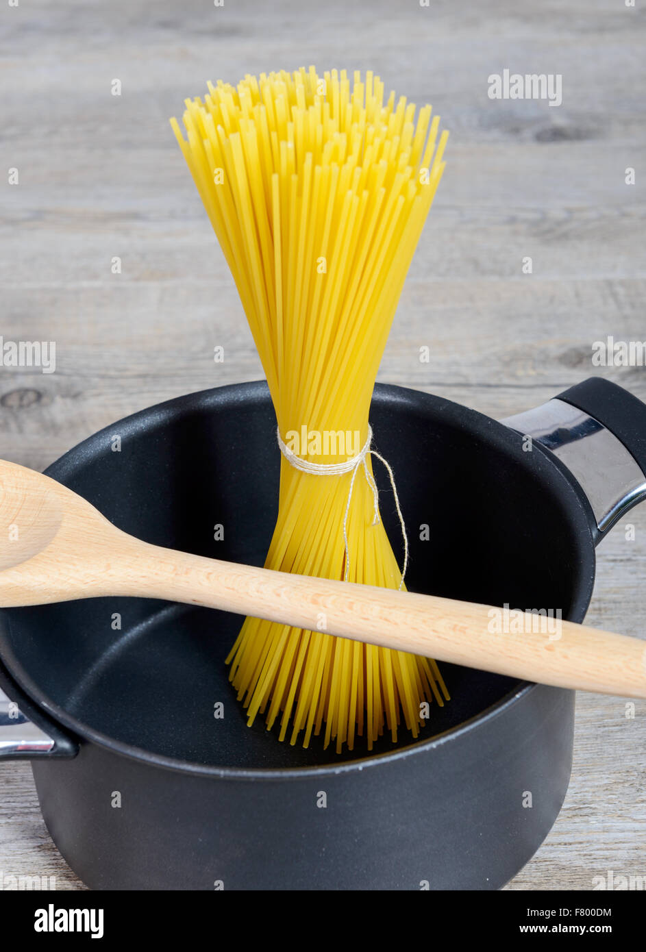 spaghetti packet in a black pan, ready for cooking Stock Photo - Alamy