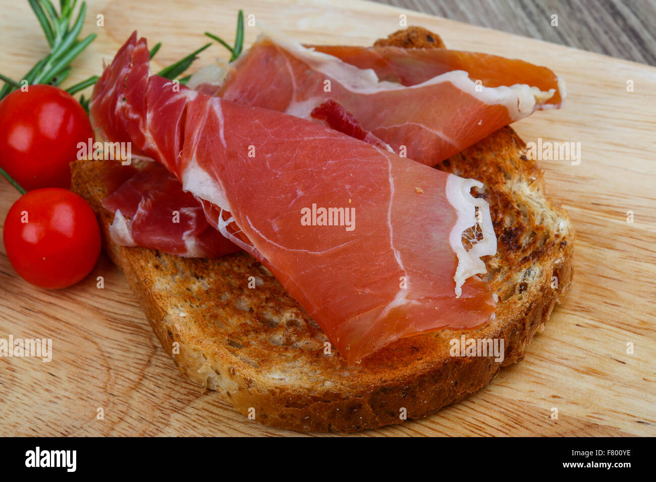 Spanish traditional snack - Jamon tapas with tomato and rosemary Stock ...